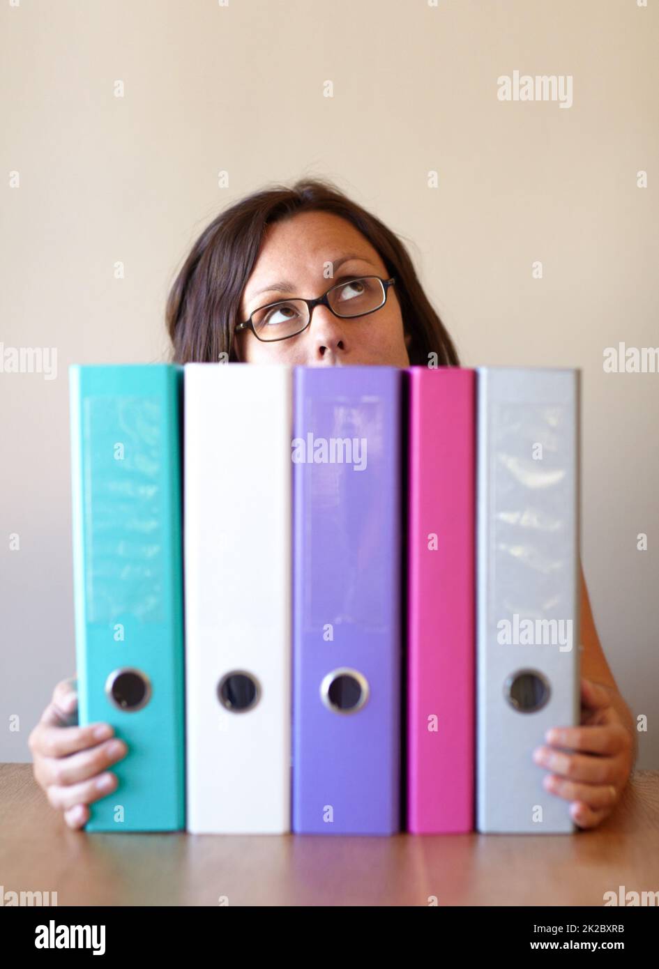 Personal tax returns can be a challenge. A young woman holding several ...