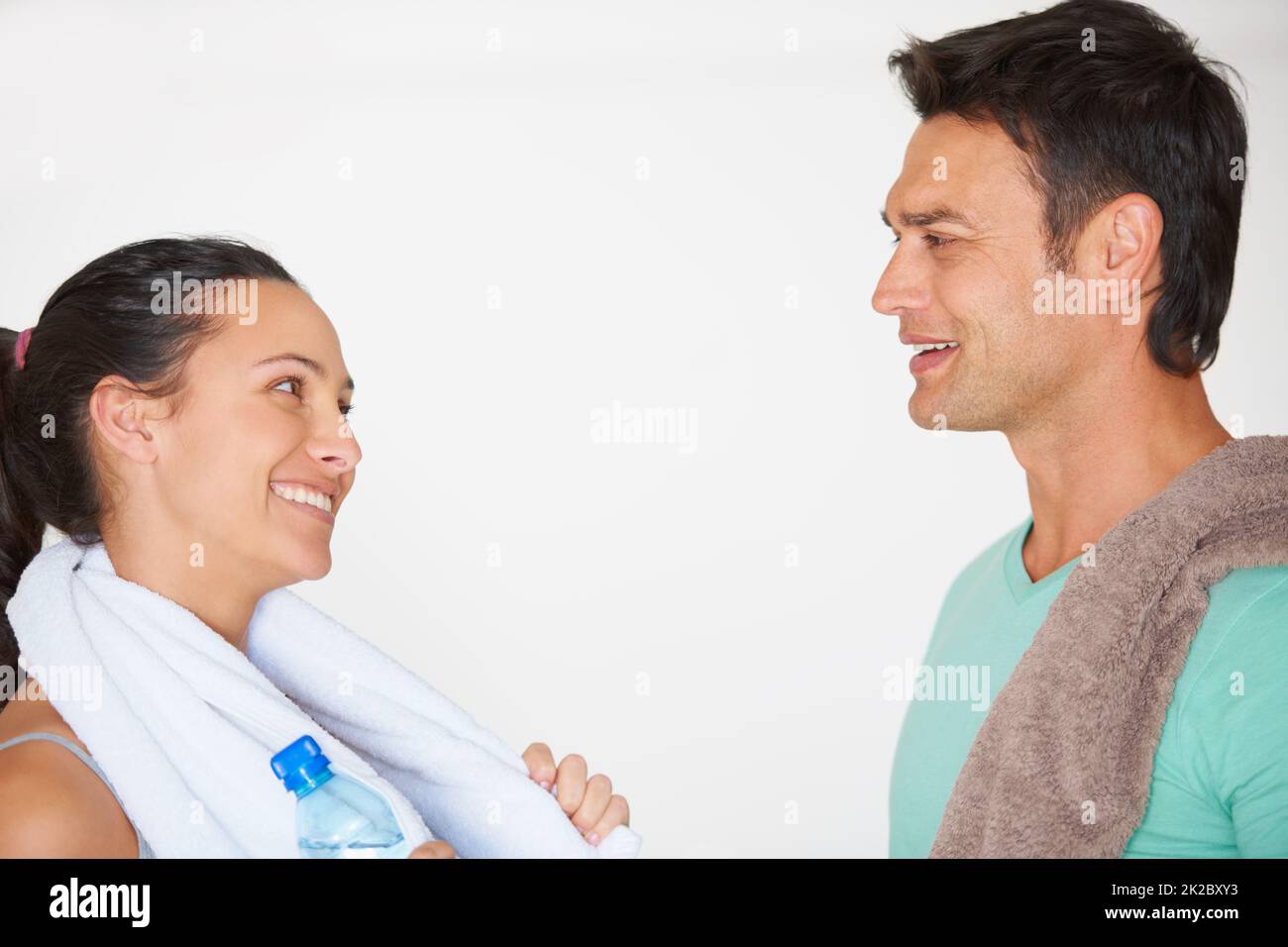 Talking about getting fit. Two young people talking to each other at ...