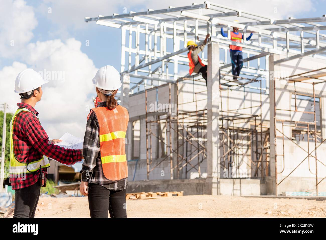 Back two architect and client discussing help create plan with ...