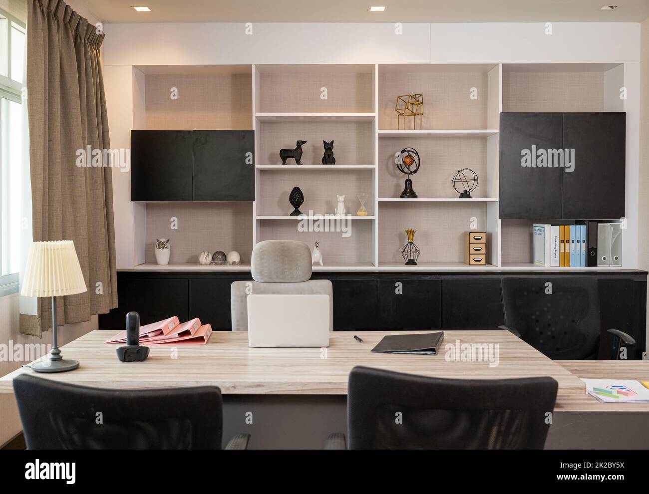 Comfortable office chair near wooden table with laptop computer Stock ...