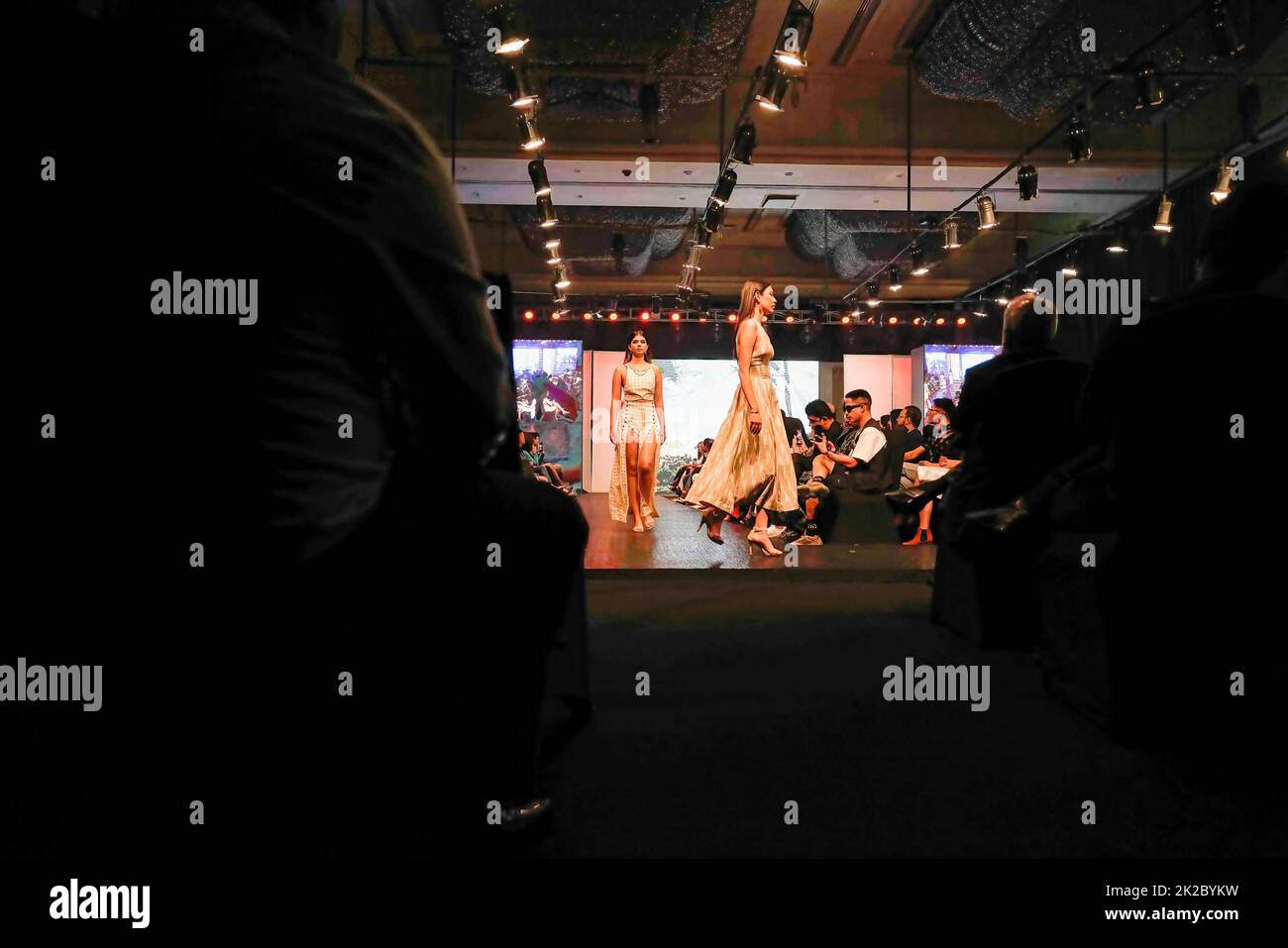 Models walk the runway wearing designer dresses on the first day of ...