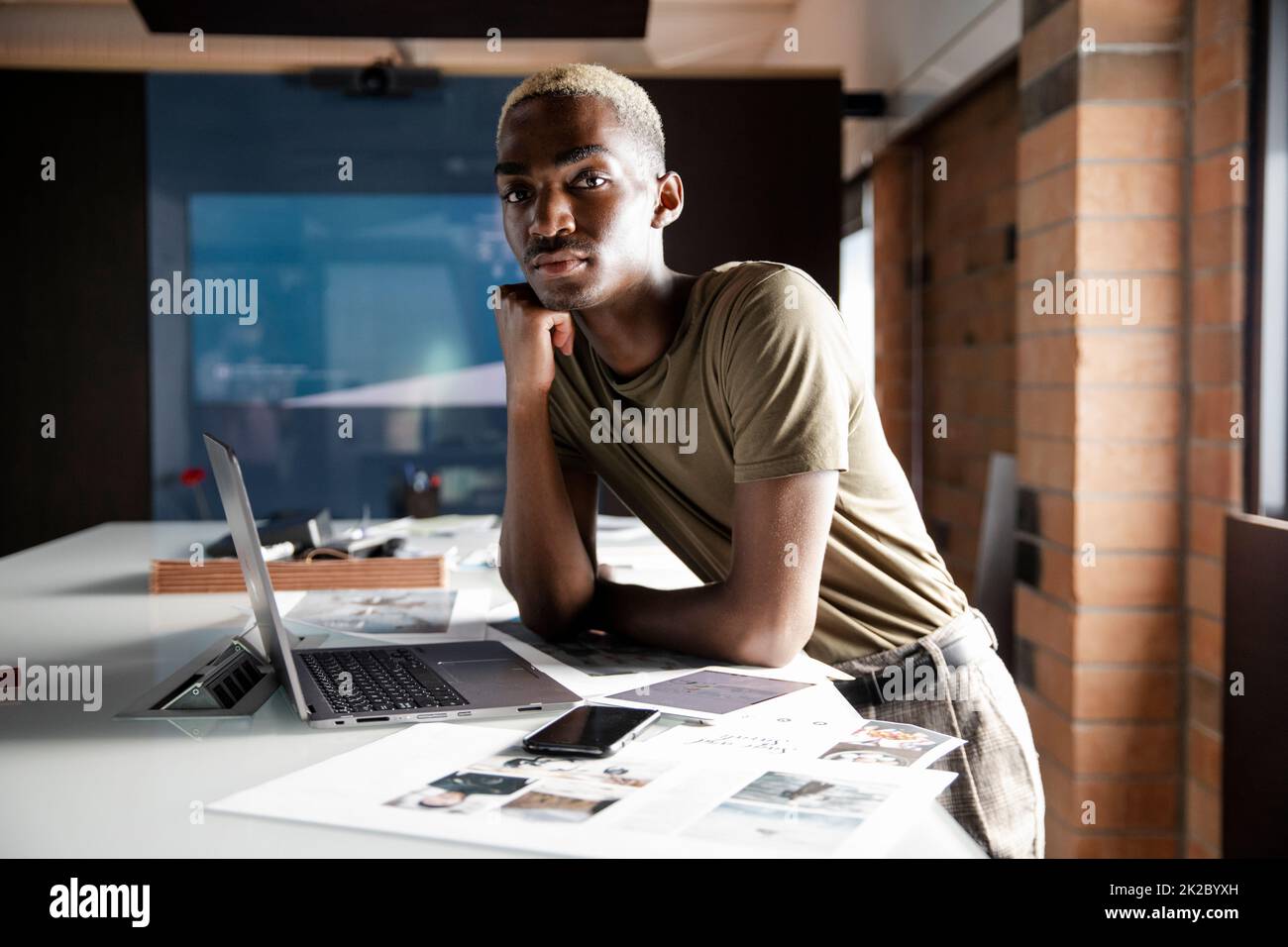 Portrait of designer with digital devices by office window Stock Photo ...