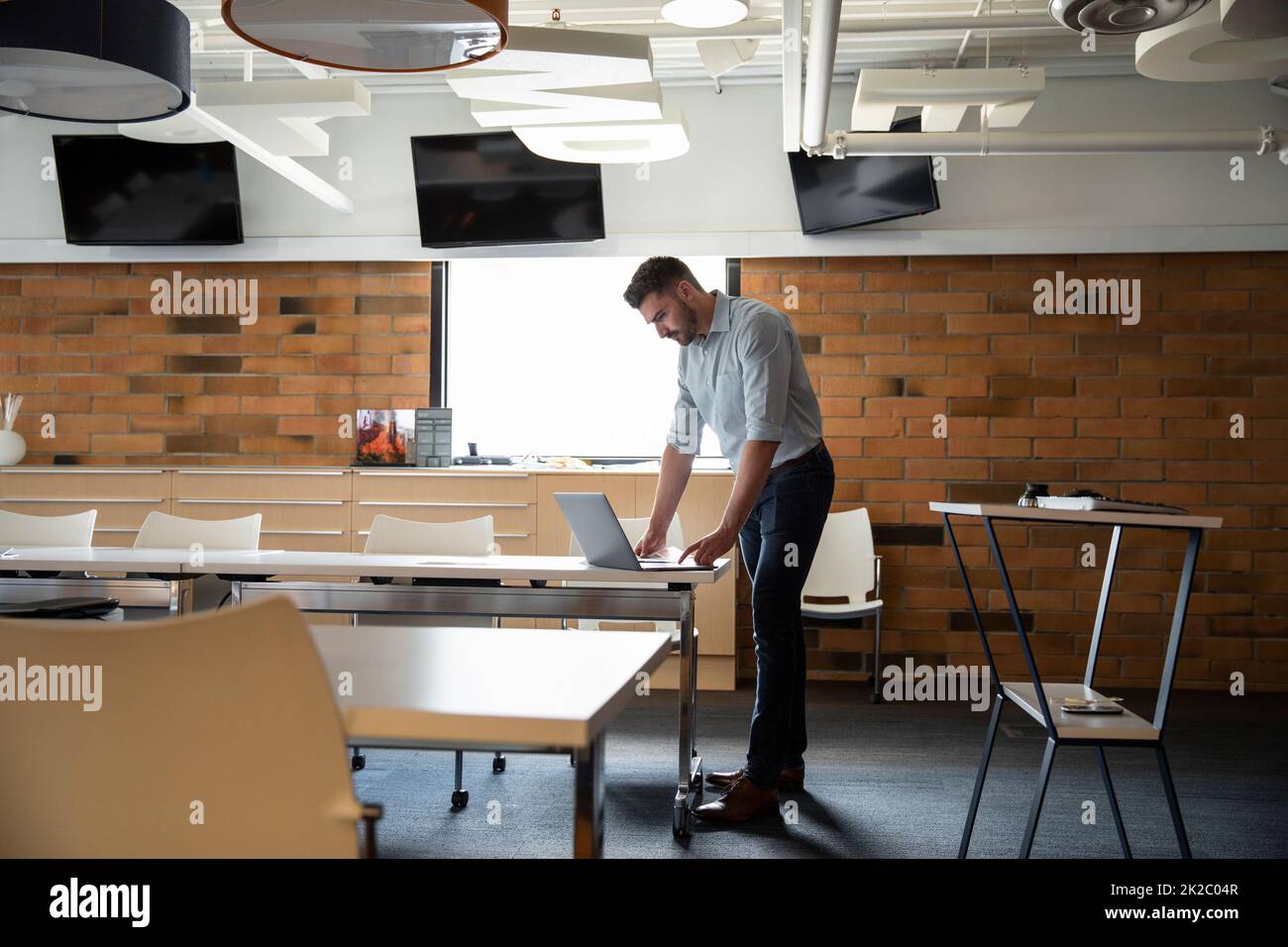 Man standing and working hi-res stock photography and images - Alamy