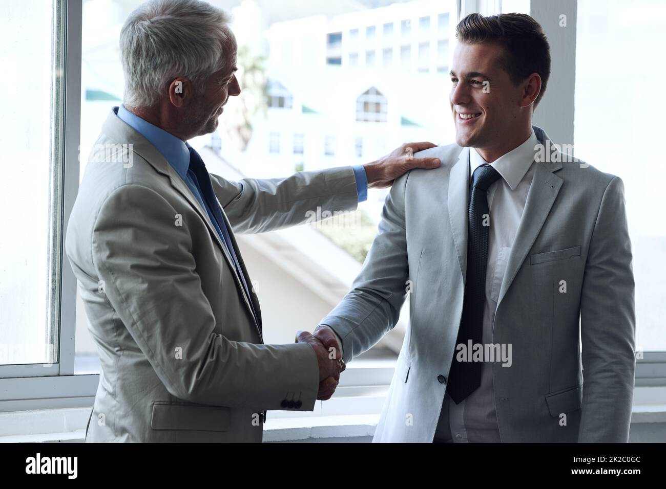 Youre going to do a great job. two businessmen shaking hands Stock ...