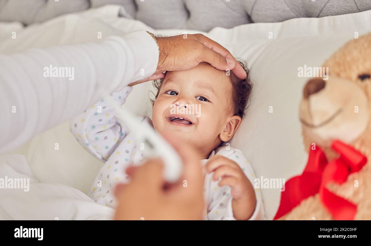 Baby, sick and fever with a mother checking the temperature of a girl ...