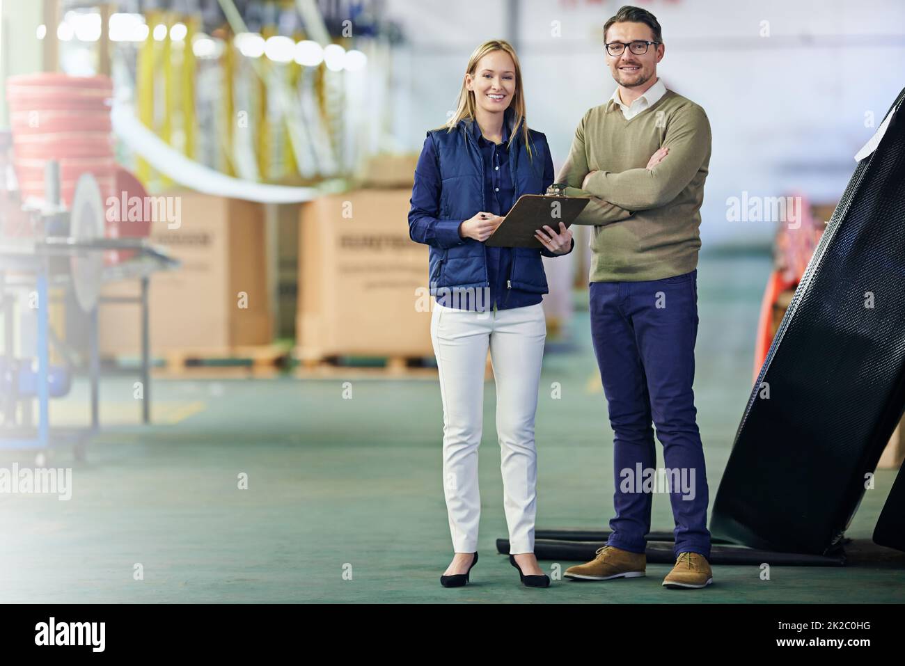 In control of the factory floor. Portrait of a two smiling managers ...