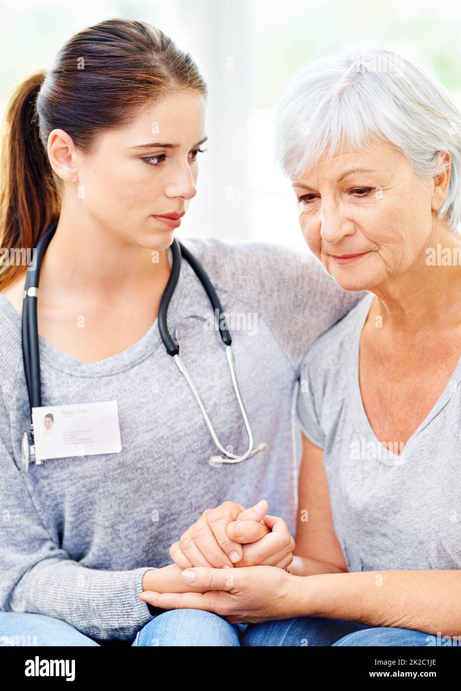 Dealing with the worst prognosis. A doctor comforting a senior patient ...
