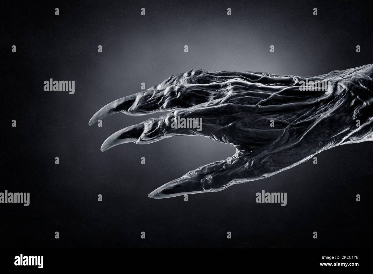 Creepy monster claw over dark misty background Stock Photo - Alamy