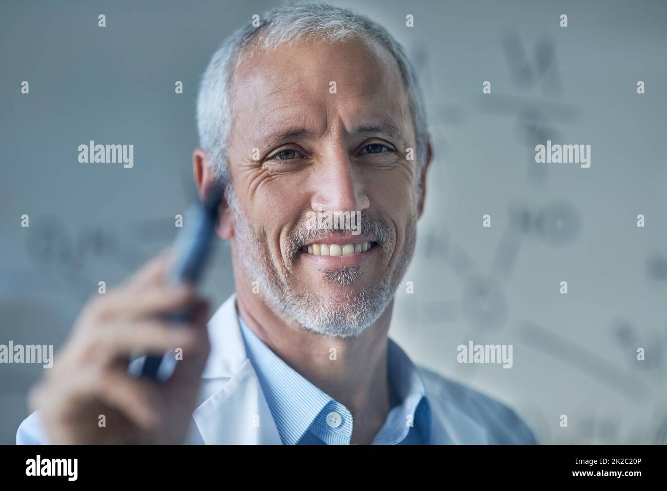 Success is in his DNA. Cropped shot of a male scientist drawing ...