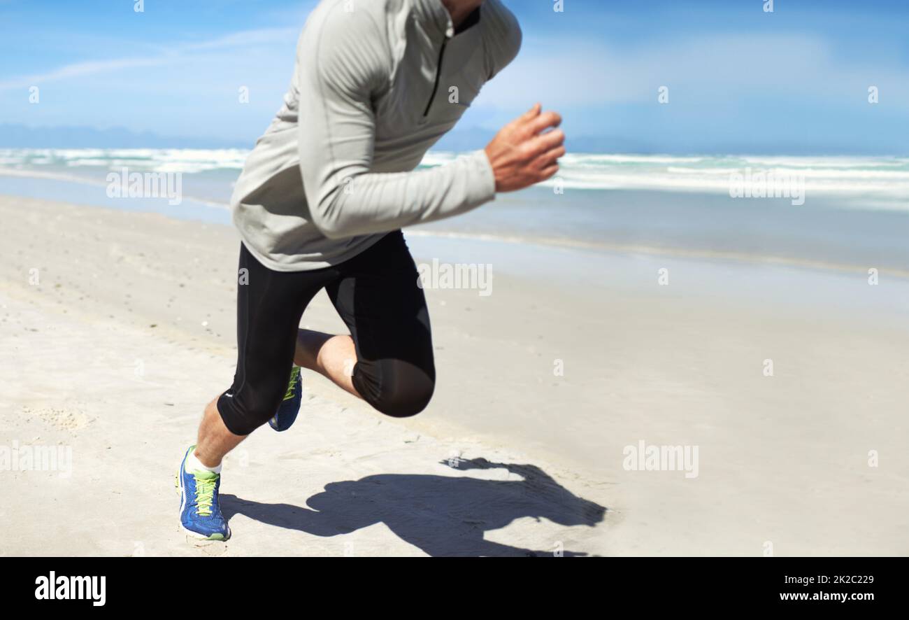 Man running along the beach hi-res stock photography and images - Alamy
