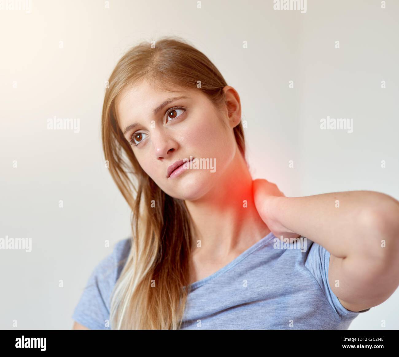 Feeling the strain and tension in her neck. Cropped shot of a young ...