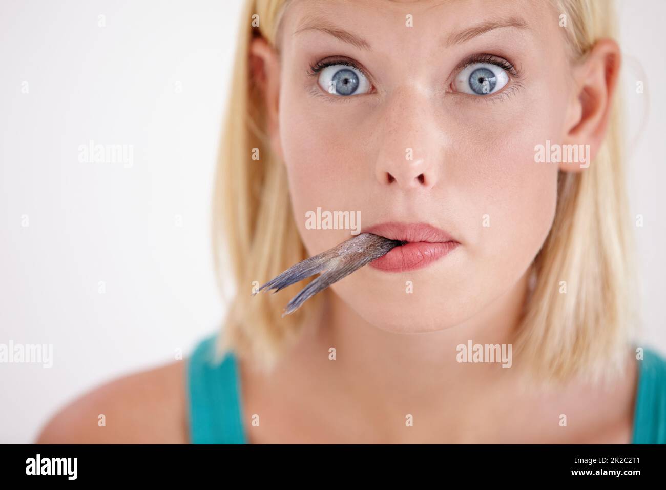 The taste of this fish is surprising. Portrait of a young woman eating ...