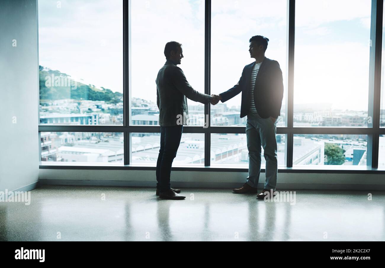 It all comes down to a handshake. Shot of two confident businessmen ...