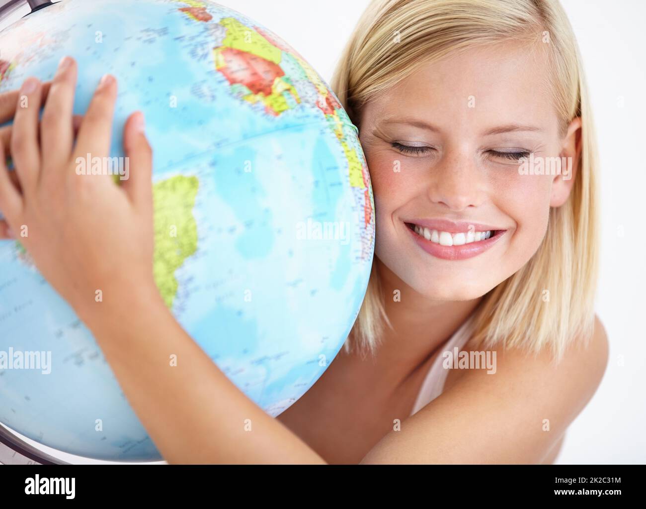 Our planet is amazing. A pretty young woman hugging a globe of the ...