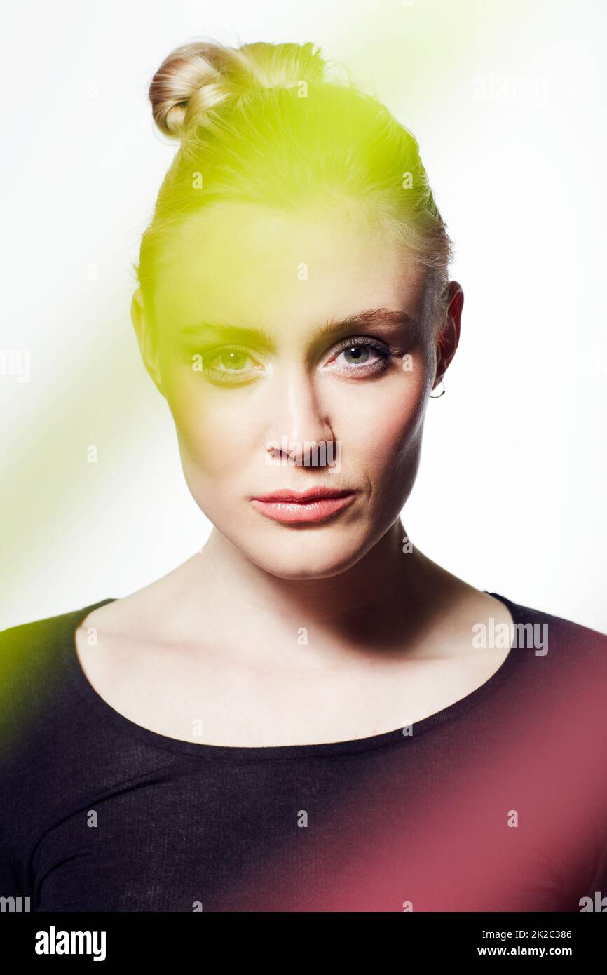 Shes serious about style. Headshot of stylish model highlighted with ...