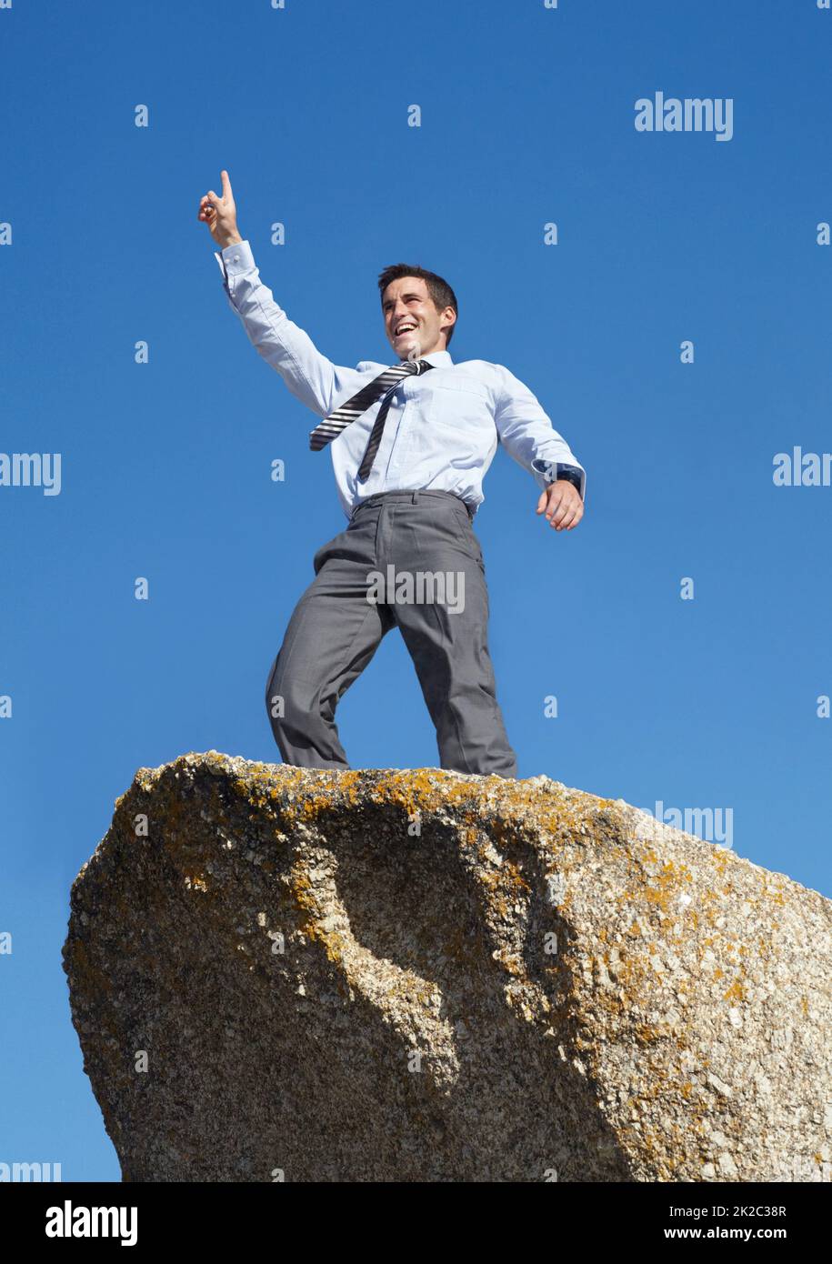 Businessman standing arms raised atop hi-res stock photography and ...