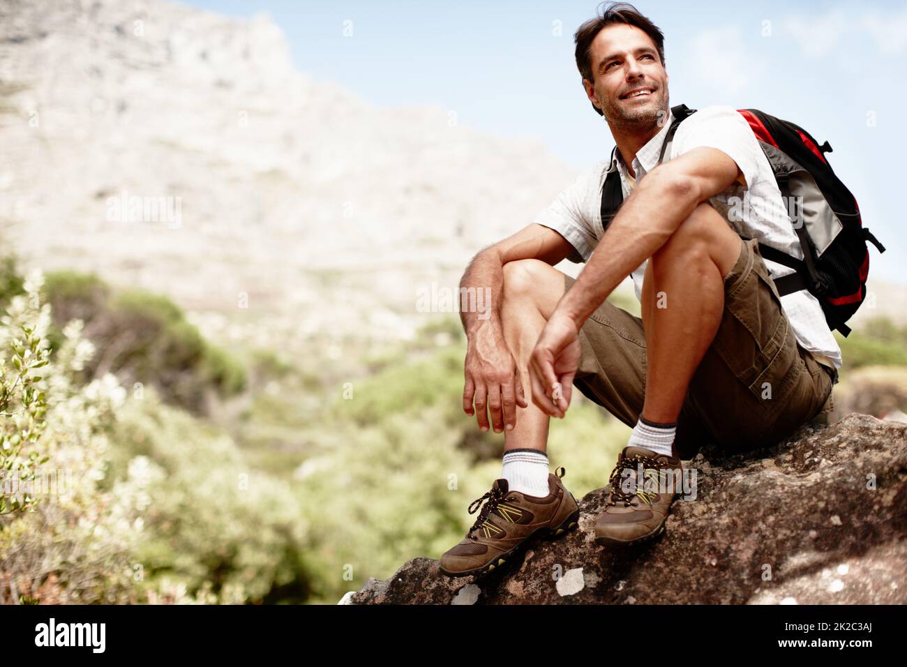 This view stretches for miles..... Handsome male hiker smiling while ...