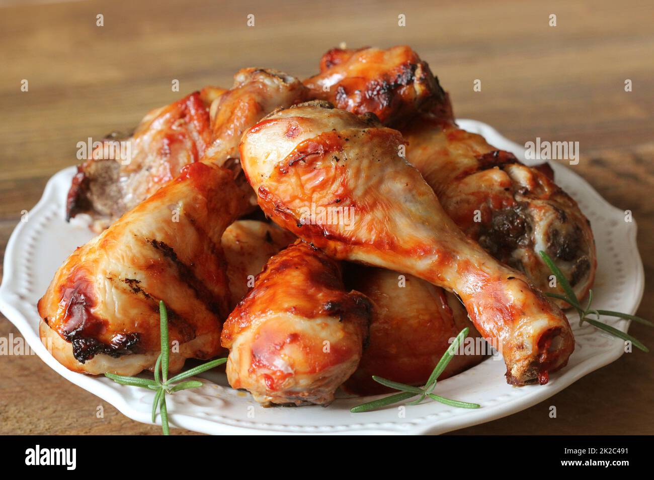 Grilled chicken legs on white plate .Rustic dinner background Stock ...