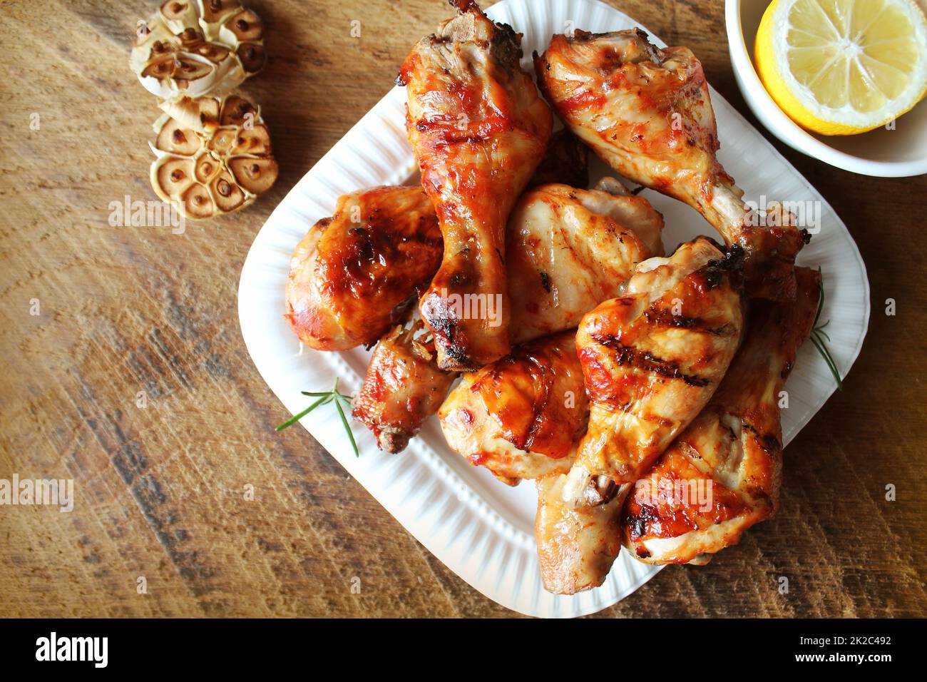 Grilled chicken legs on white plate .Rustic dinner background Stock ...