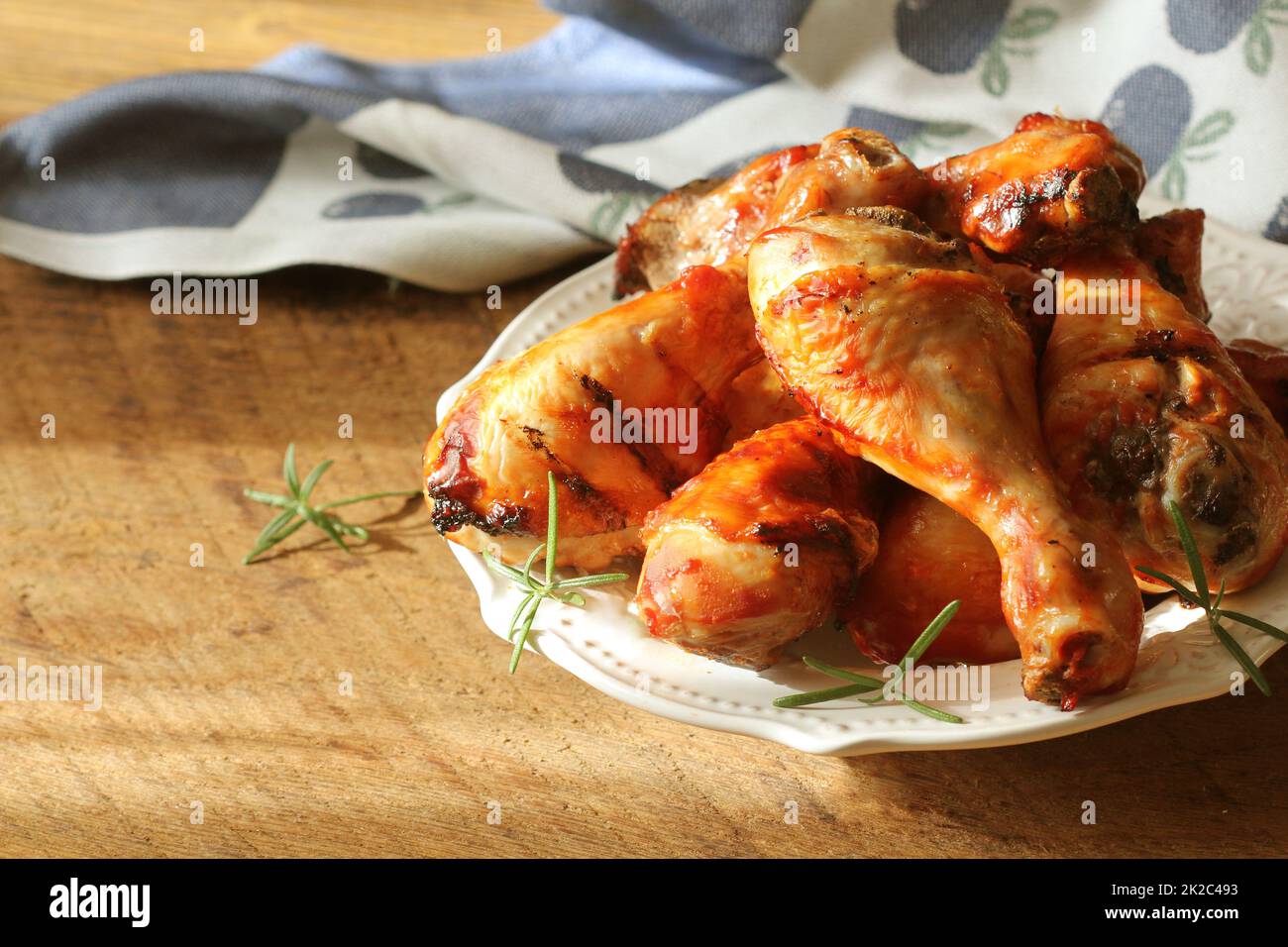 Grilled chicken legs on white plate .Rustic dinner background Stock ...