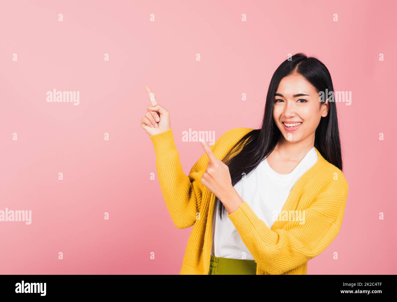 woman standing makes gesture two fingers point upwards above presenting ...