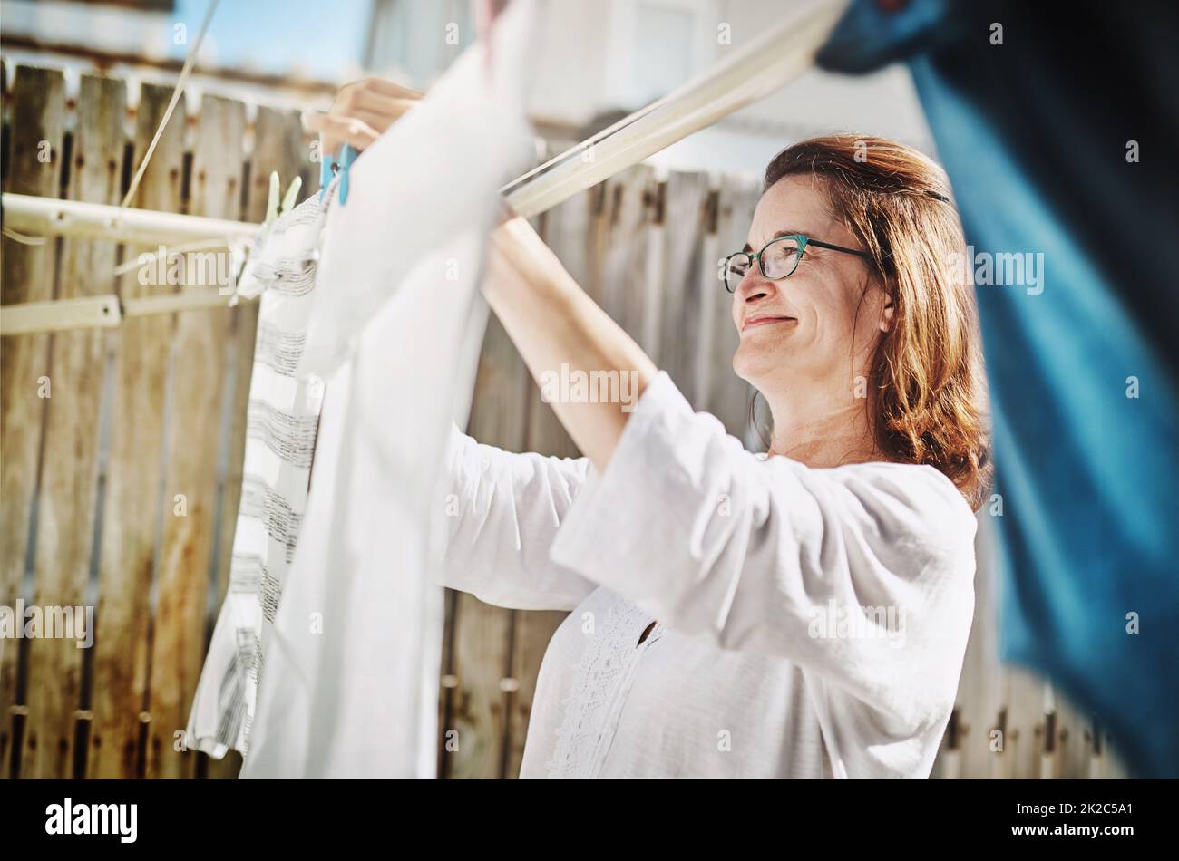 Woman hanging washing outside hi-res stock photography and images - Alamy