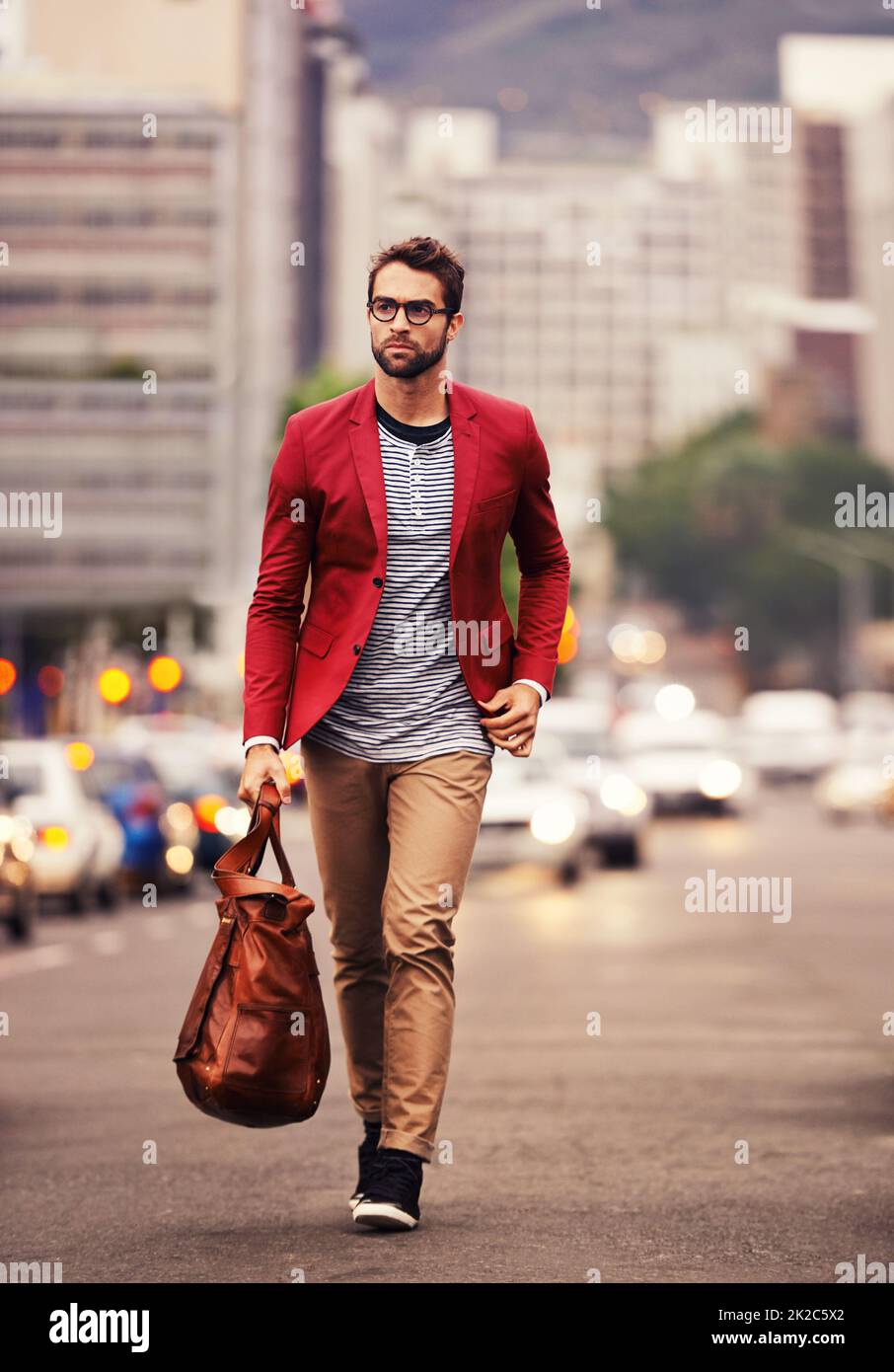 Styled for the city. Shot of a handsome young man taking a walk through ...