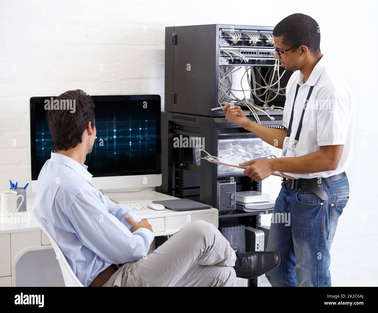 Onsite IT support. A young IT specialist ready to fix a server Stock ...