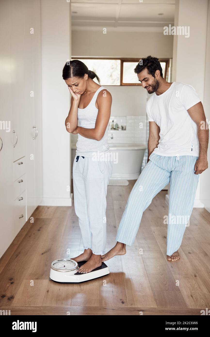 He Loves Pranking Her Shot Of A Man Tricking His Wife While She Weighs