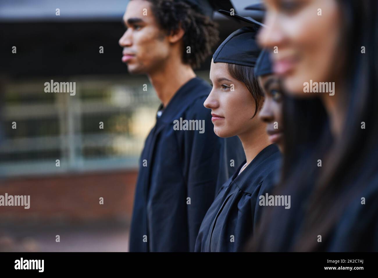 Facing their future as graduates. A group of solemn college graduates ...