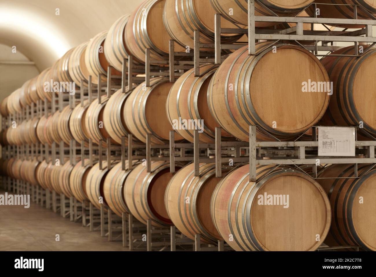 Mass producing wine. Stacked barrels of wine at a wine distillery Stock ...