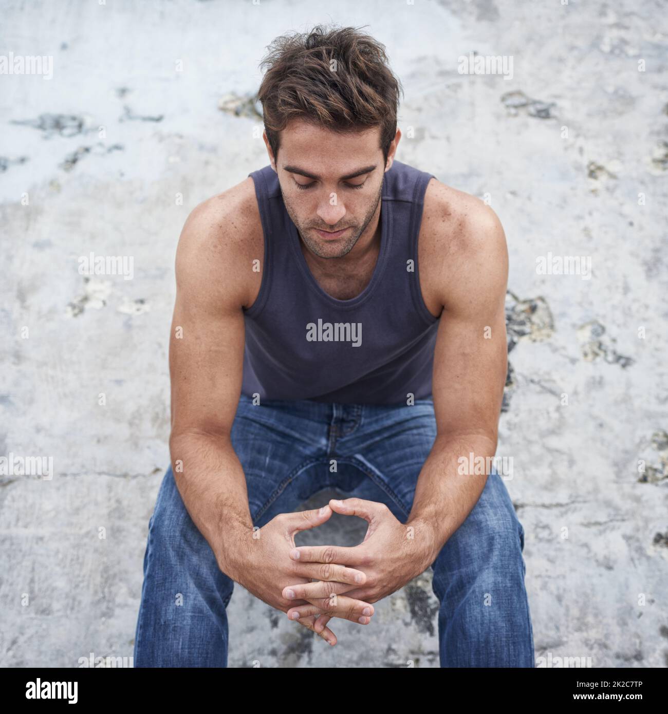 Thinking about the future. A young man sitting outside Stock Photo - Alamy
