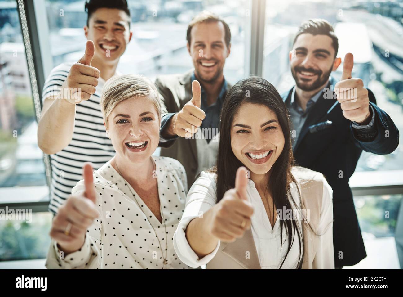 Group people looking camera thumbs up hi-res stock photography and ...
