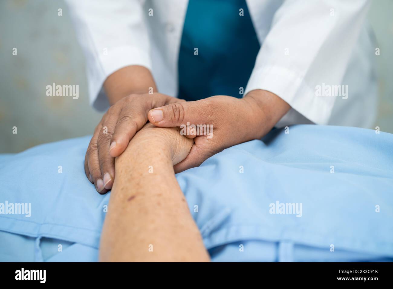 Doctor holding touching hands Asian senior or elderly old lady woman ...