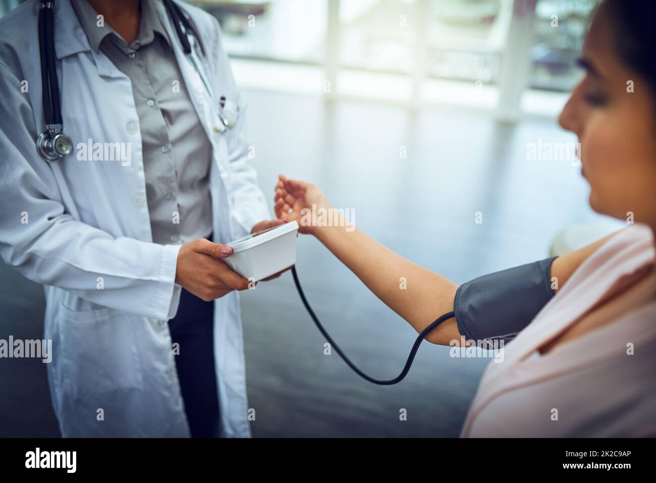 Female doctor checking blood pressure of a patient hi-res stock ...