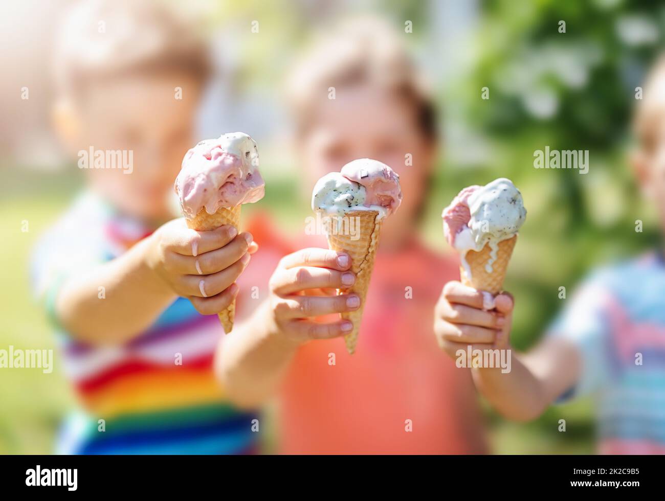 Group of children in the park eating cold ice cream Stock Photo - Alamy