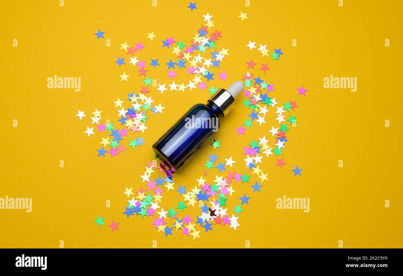blue glass bottle with a pipette. Container for cosmetics, serum and ...