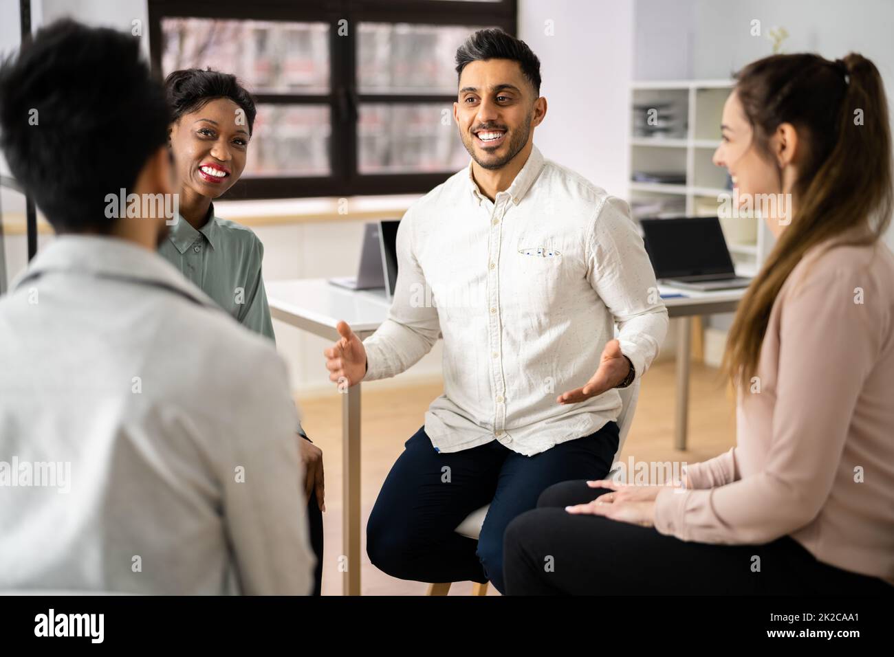 Two People Consoling Young Man During Group Therapy Stock Photo - Alamy