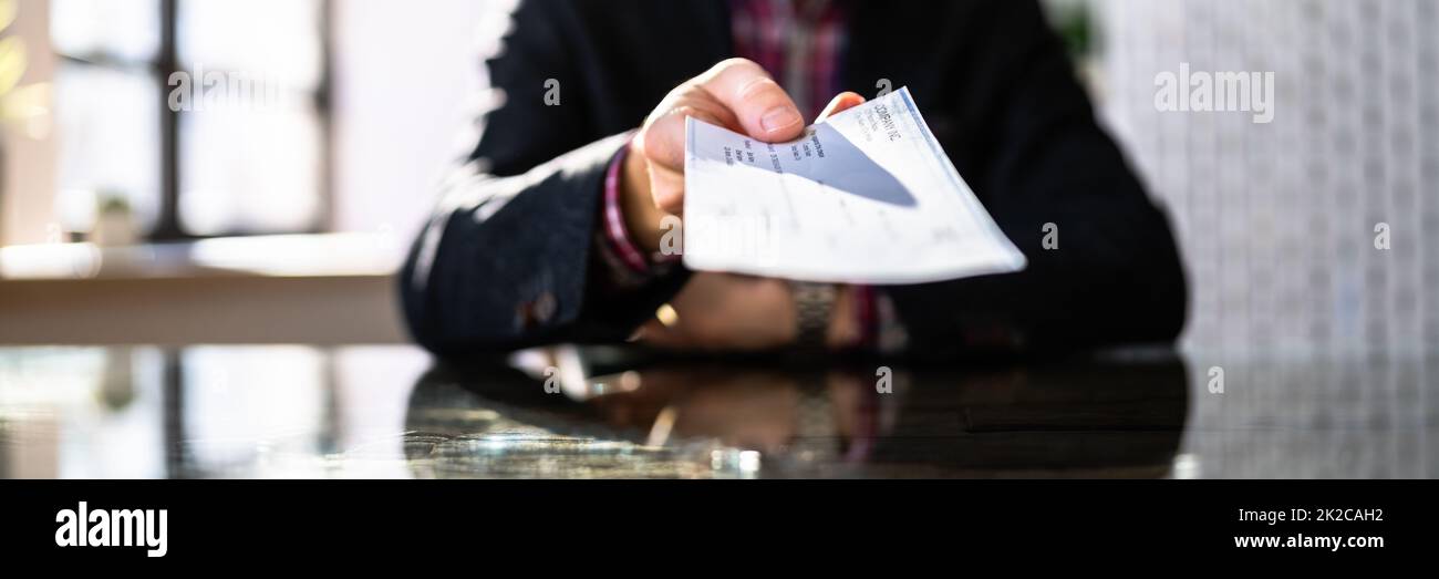 Giving Paycheck Or Payroll Cheque Stock Photo - Alamy