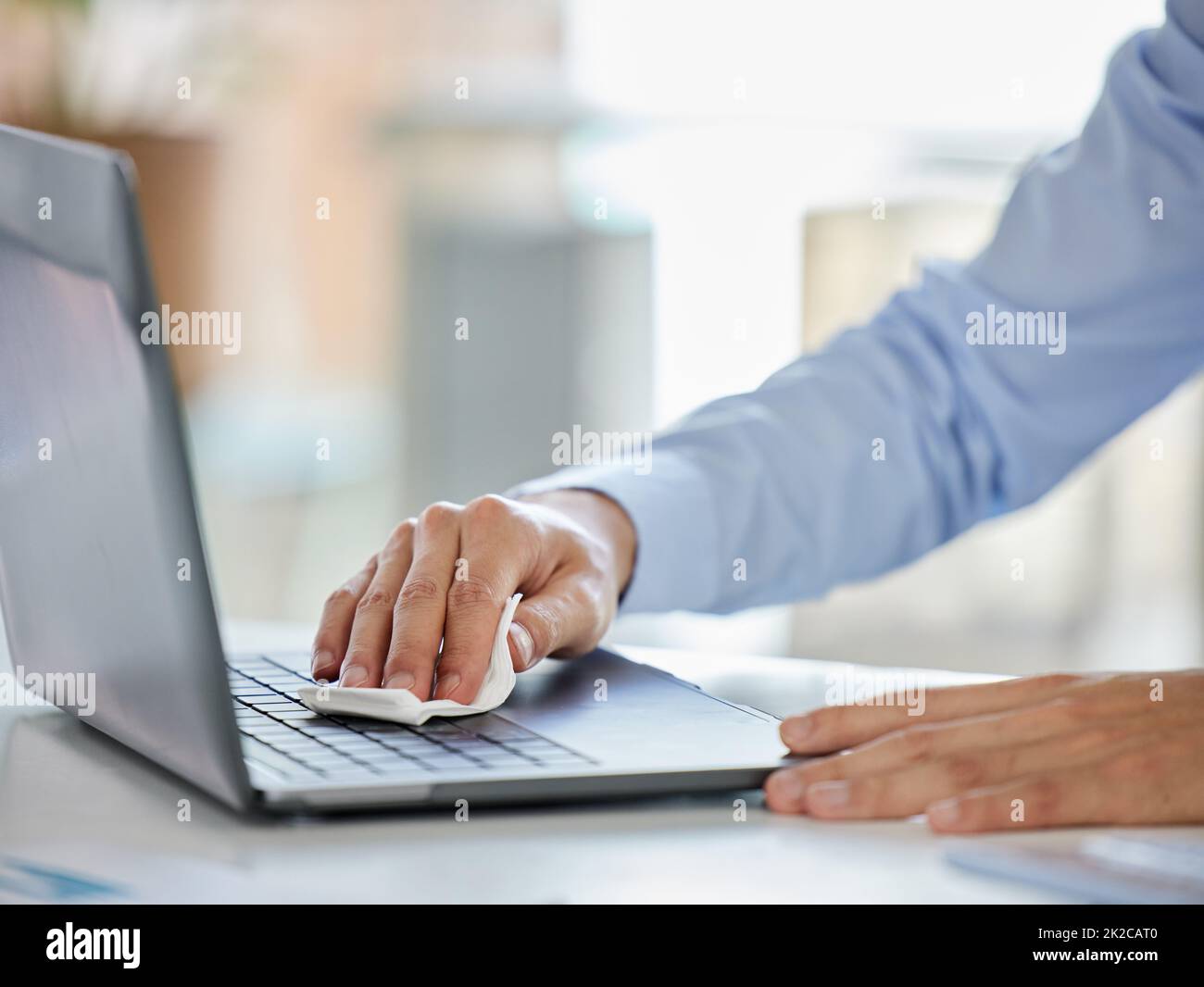 Businessman, laptop and covid sanitizer wipe for cleaning keyboard ...
