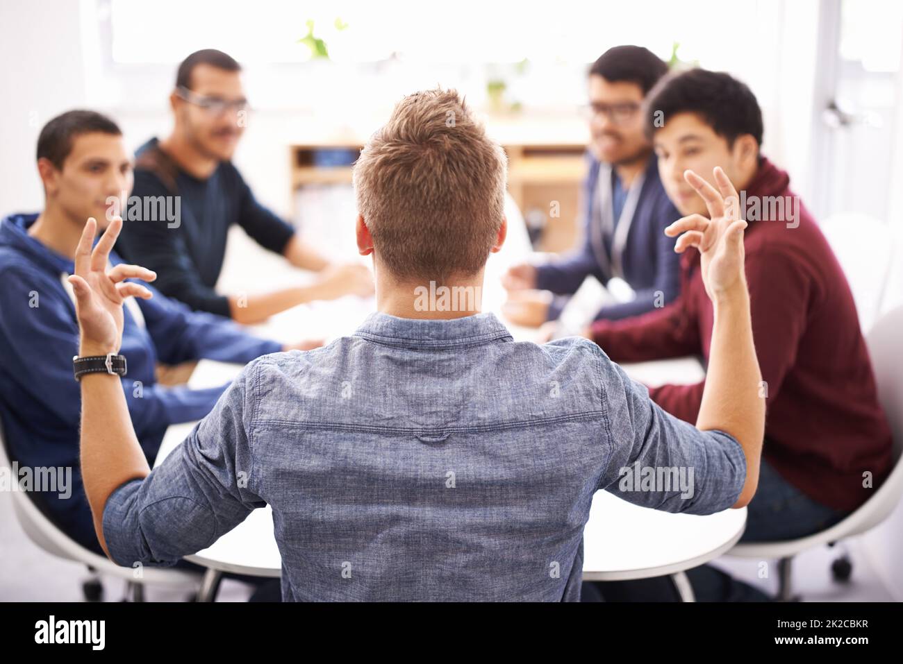 Brainstorming some ideas with my colleges. a group of guys having a ...