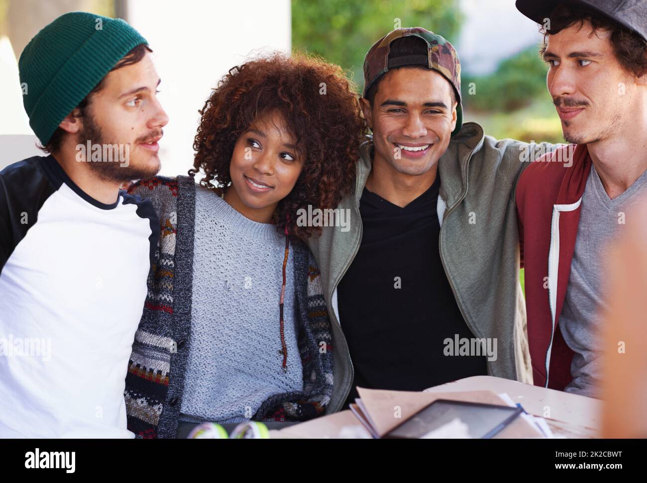 I love these weirdos. A group of friends around an outdoor table Stock ...