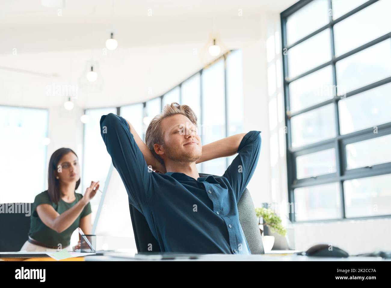 Man leaning back in chair hi-res stock photography and images - Alamy