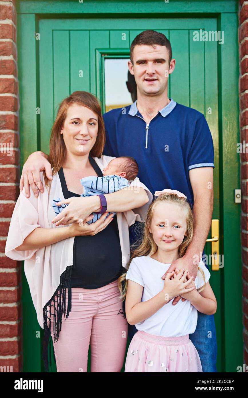 They are one happy bunch. Portrait of a cheerful young family grouped ...