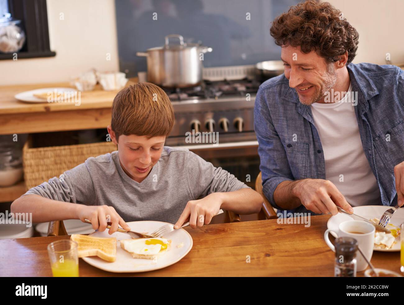 Dad makes the best breakfast. A cropped shot of a young boy and his dad ...