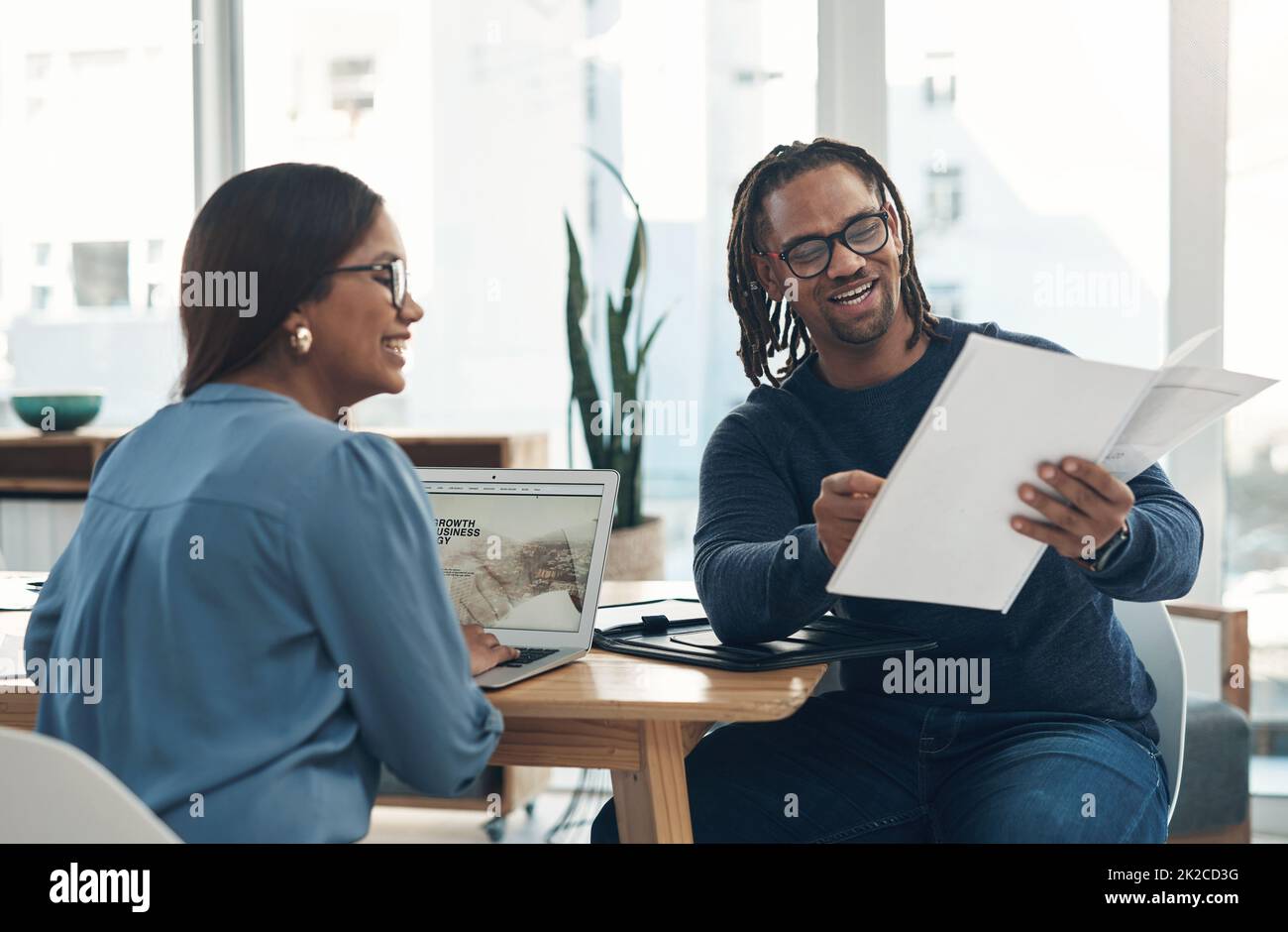 Our plans are all looking perfect. Shot of two businesspeople going ...