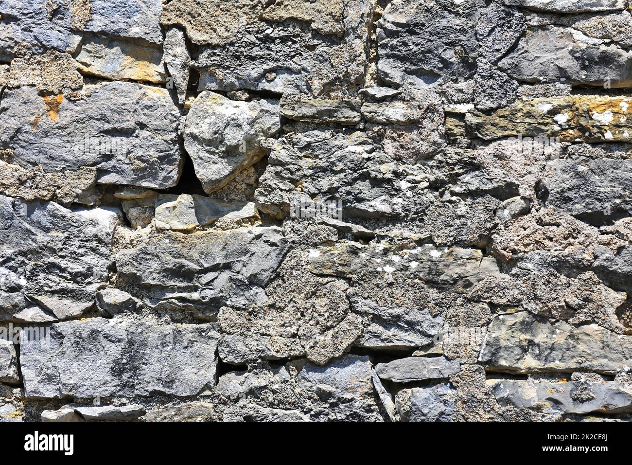 Wall made of irregular rubble stone as a background Stock Photo - Alamy