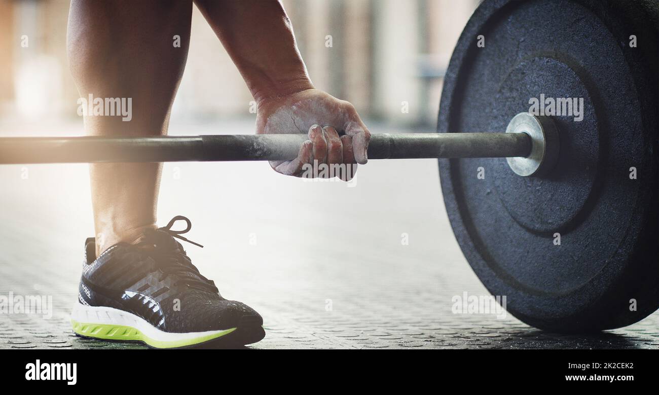Lift with your legs. Cropped shot of an unrecognizable young man ...