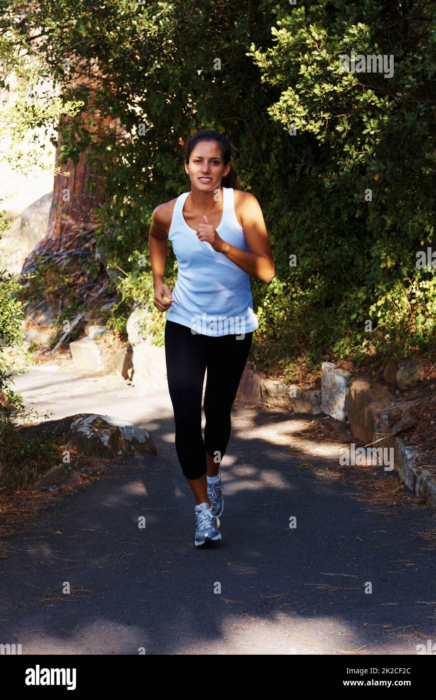 Young woman jogging. Full length of young healthy woman jogging ... Young woman jogging. Full length of young healthy woman jogging ...