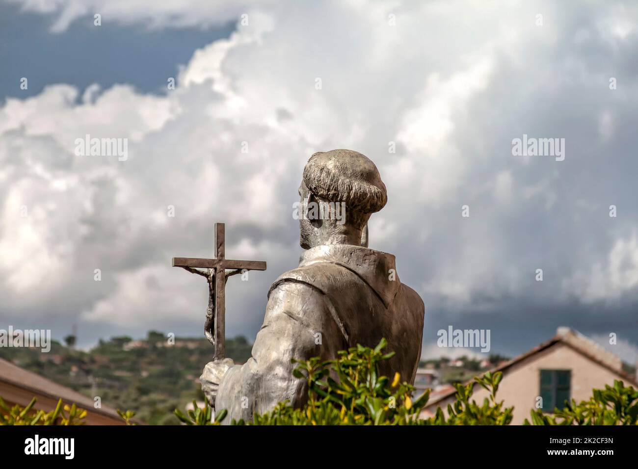 Figure of a friar standing with a cross in his hand Stock Photo - Alamy